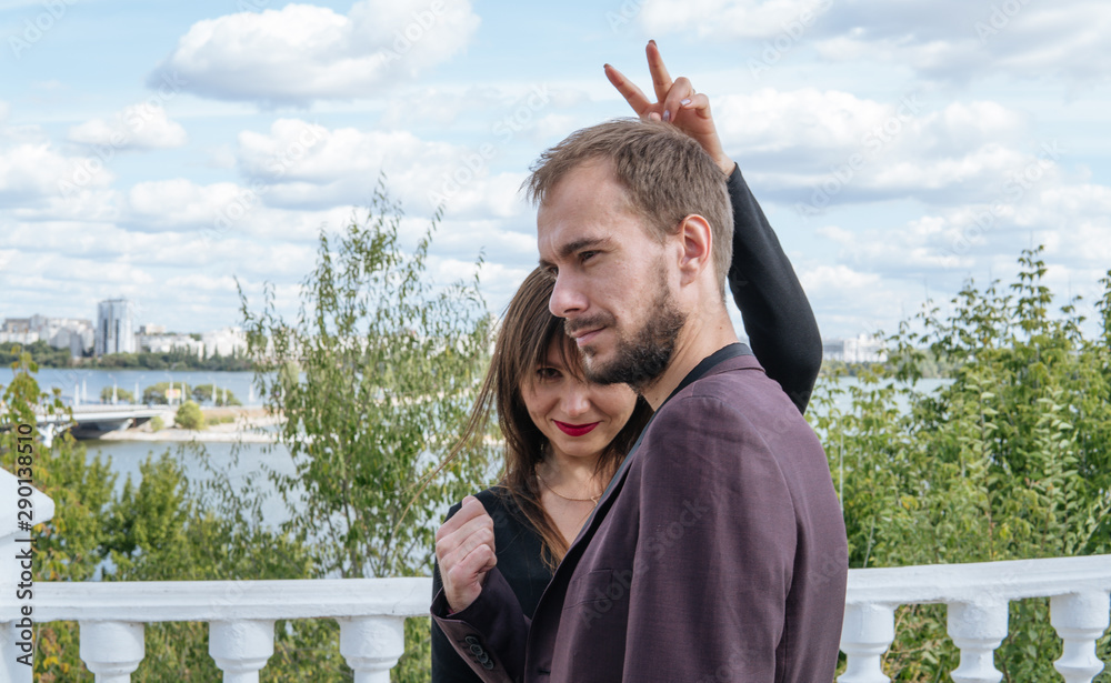 A happy loving couple are fooling around. A beautiful woman with the ...