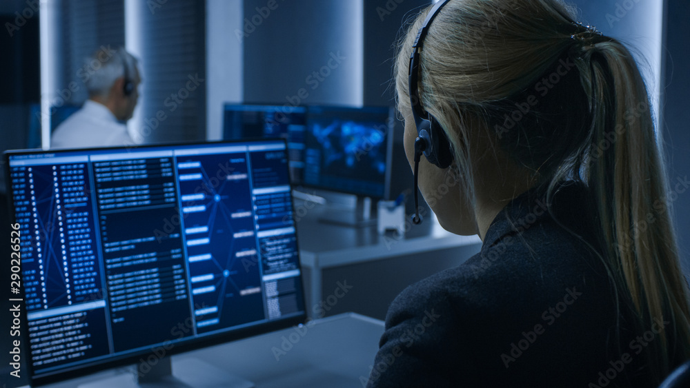 Back View of the Female Controller wearing Headset Working on Personal ...