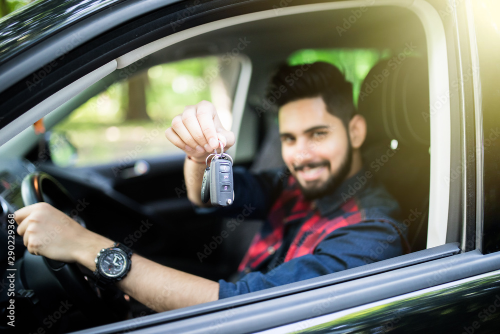 Happy indian man showing the key of his new car Stock Photo | Adobe Stock
