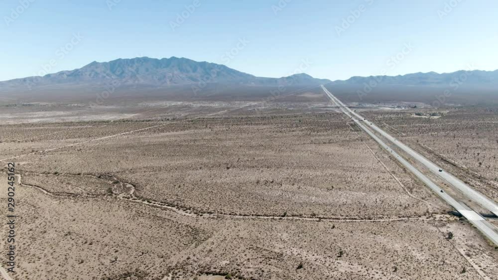High altitude aerial shot of the Mojave desert with interstate 15 on ...