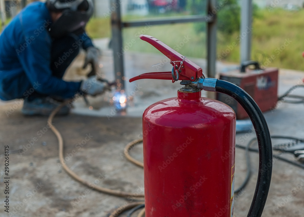 Fire extinguisher are used to prevent fire in welding steel work. Stock ...