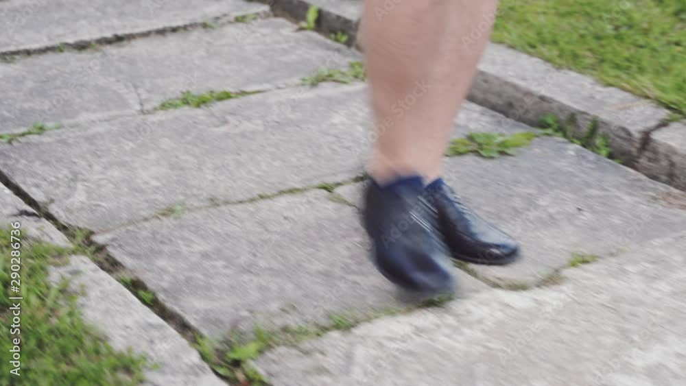 Leg and foot wearing shoe stepping into a pile of poop or shit or muck ...