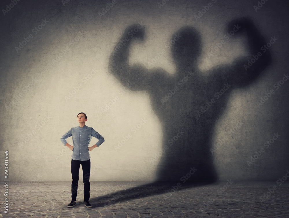 Brave teenager boy facing his fears as a powerful hero. Guy casting a ...