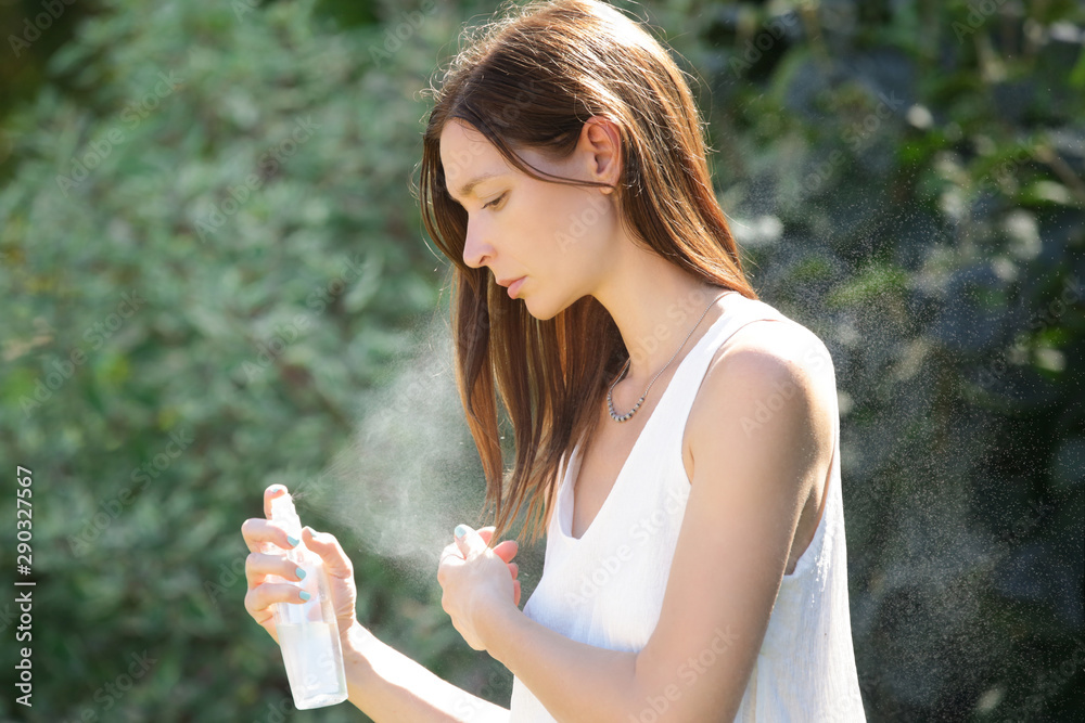 Woman refreshing with thermal water against summer heatwave. Woman ...