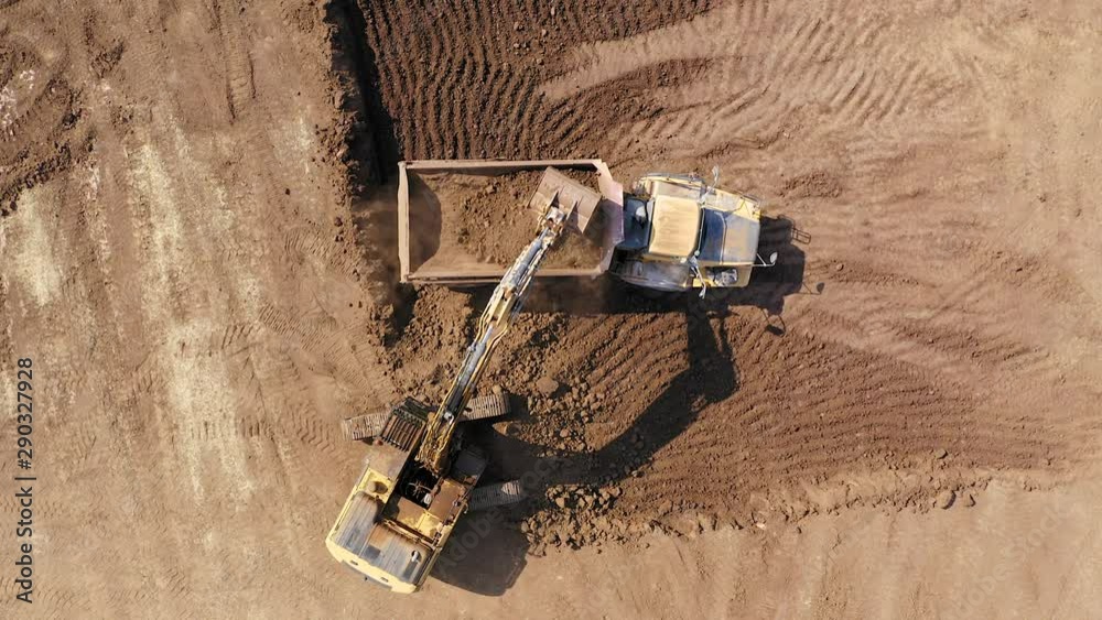 Excavator loading soil onto an Articulated hauler Truck, Top down ...