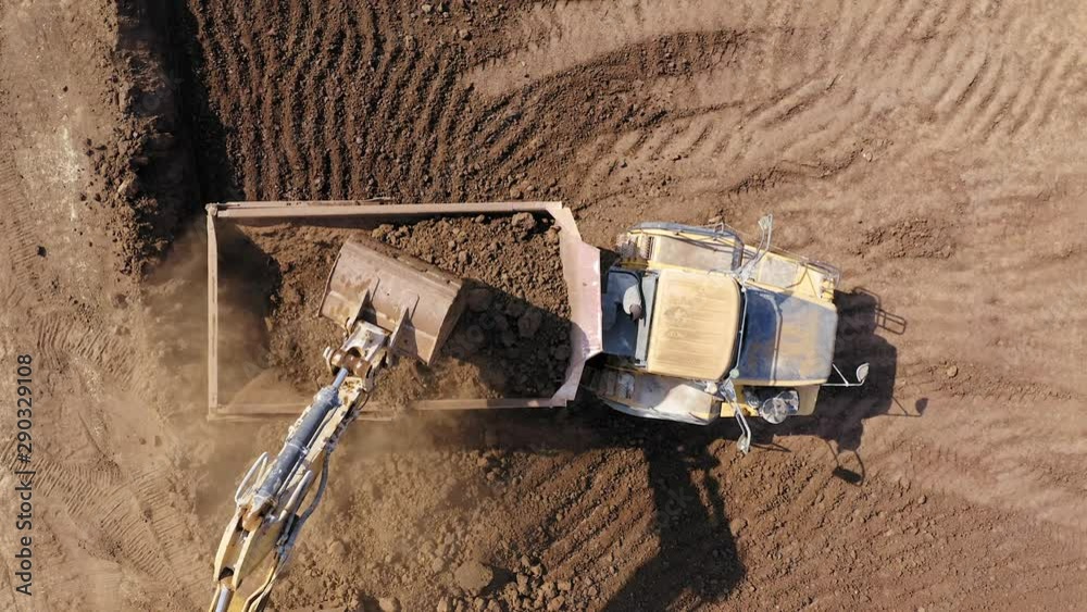 Excavator loading soil onto an Articulated hauler Truck, Top down ...