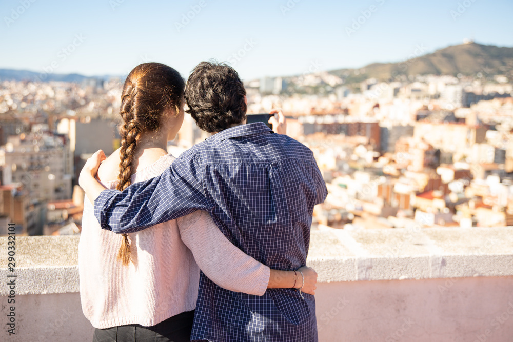 Pareja de novios abrazados haciendo fotografías del paisaje urbano ...