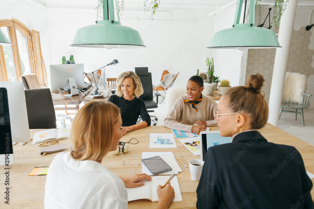 Female team working in a modern office. Stock Photo | Adobe Stock