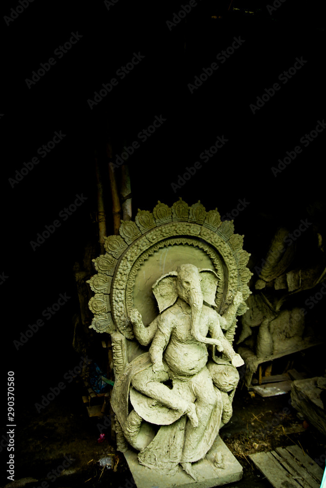 Artist is busy to create clay statue of God Ganesha, A Clay model ...
