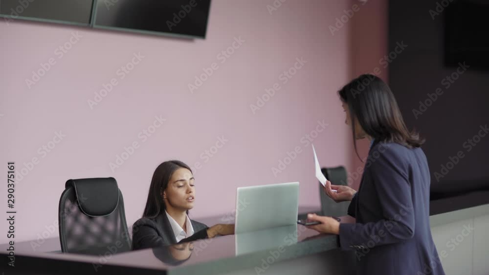 Middle aged businesswoman having conflict with young receptionist at ...