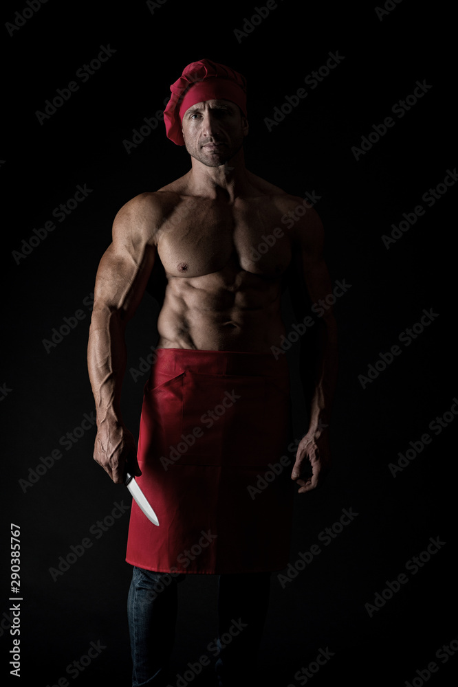 Confident in his cooking skills. Athletic man hold cooking knife black ...