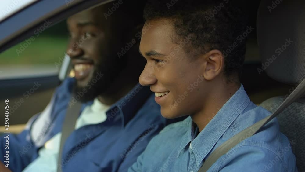 Smiling african-american teacher comforting teenage student, driving ...