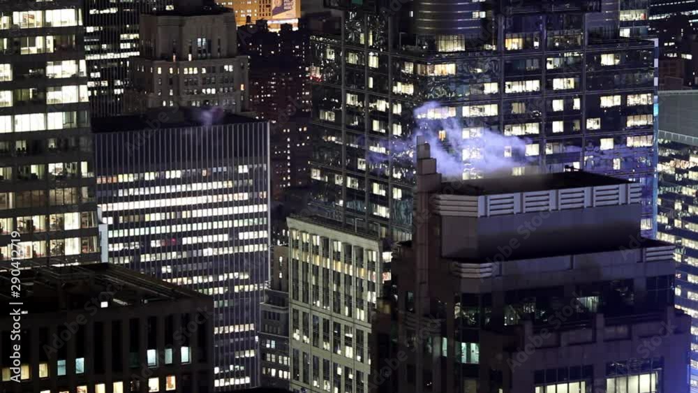 Steam from roof of building in Manhattan at night, New York, United ...