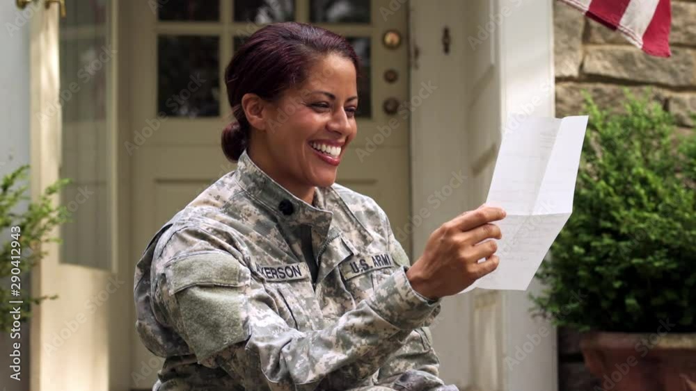 Smiling African American soldier reading letter on front stoop Stock ...