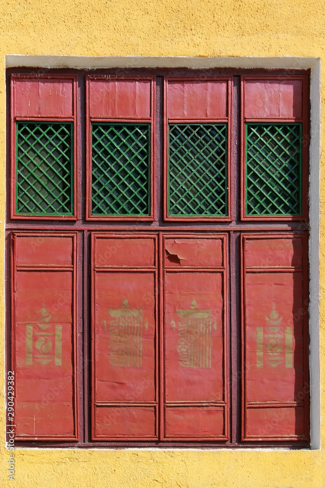 Red window on yellow building in Vajradhara Temple, part of the ...