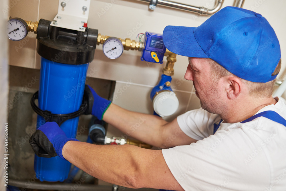Plumber work. Installing water filter into system Stock Photo | Adobe Stock