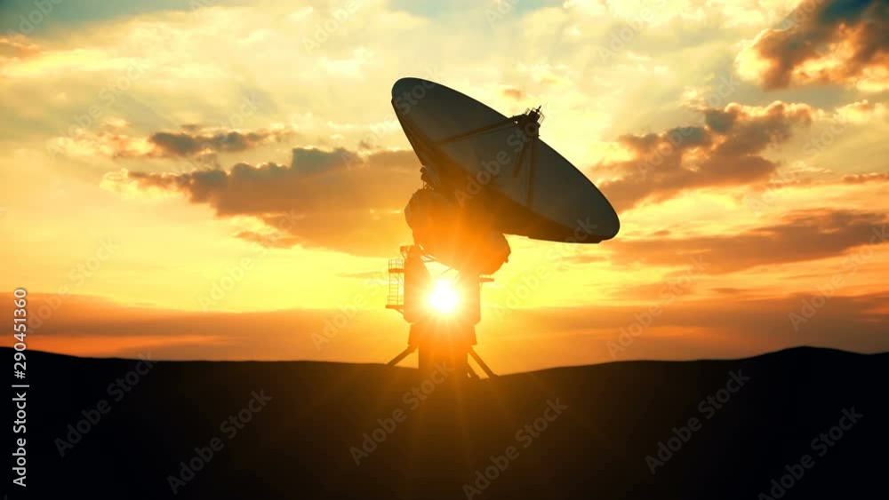 Huge military radar raising its antenna dish exploring evening sky ...