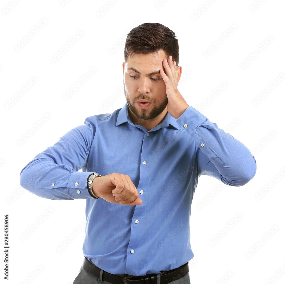Portrait of troubled businessman looking at watch on white background ...
