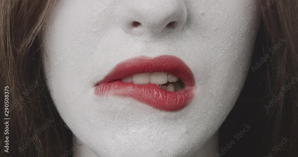 She is biting her lip - close-up of a teenage girl, who is made-up for ...