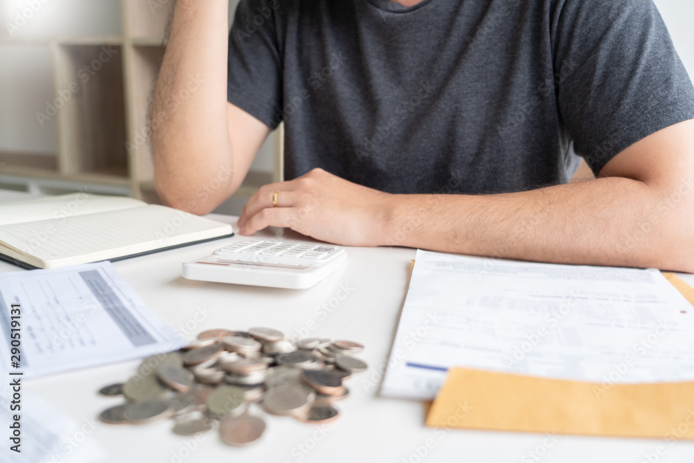 Man using calculator and calculate bills receipt in home expenses ...