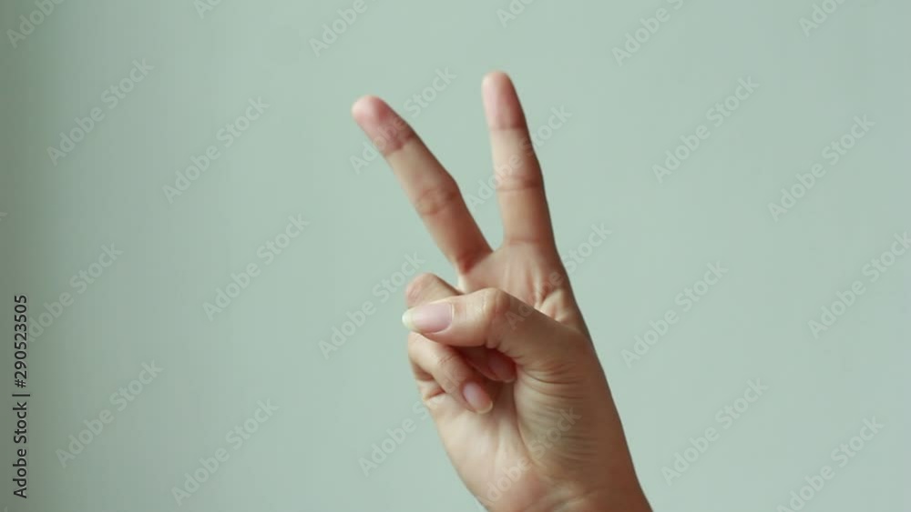 Female one hand holding two fingers up in sign language.two fingers up ...