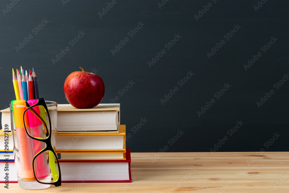 World teacher day - apple and books with pencils and eyeglasses on ...