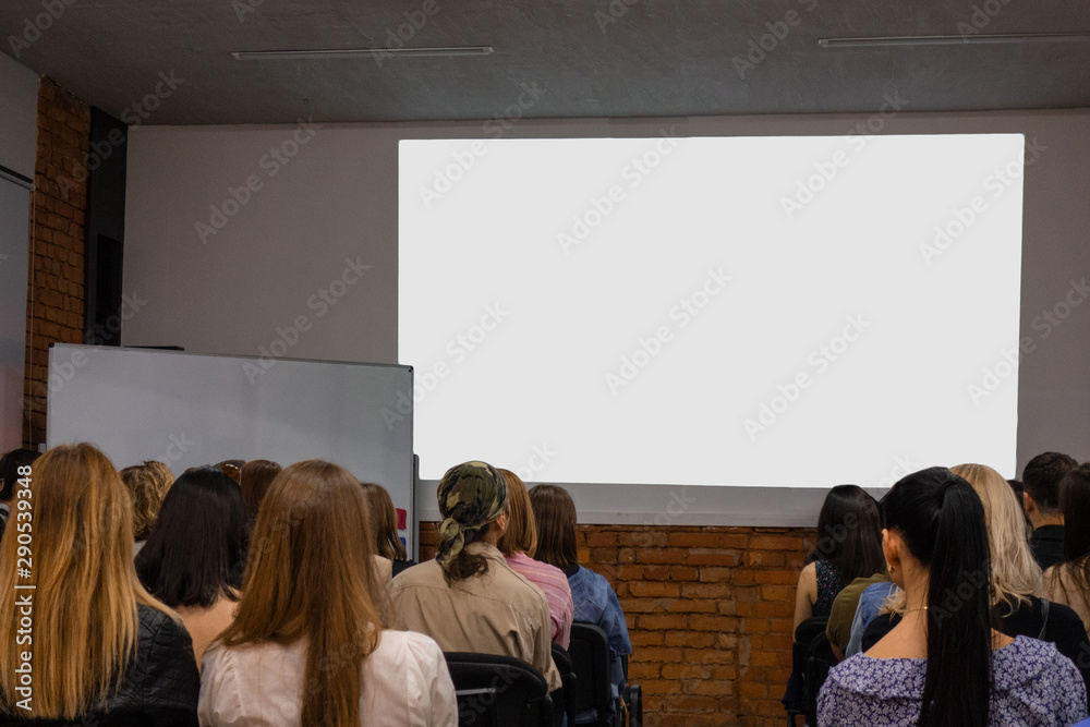 People in auditory during presentation or seminar. Teenagers or young ...