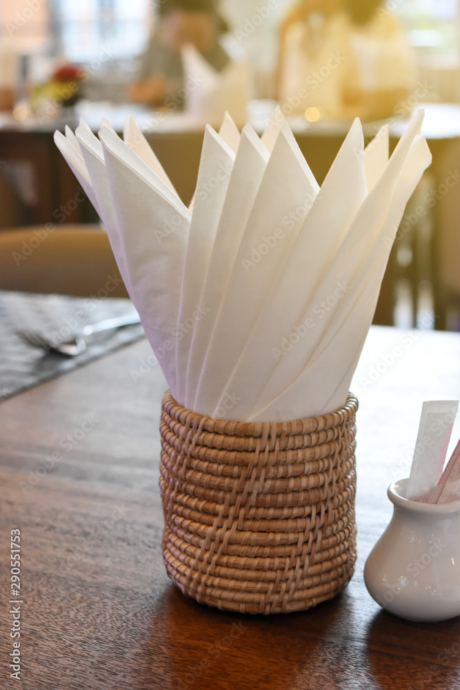 Tissue paper in basket box made from rattan put on the dining table ...