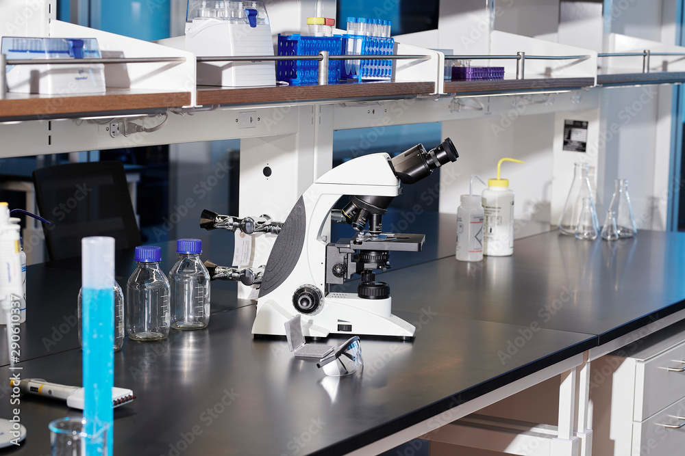 Research Microscope on Medical Science Bio Lab Bench Surrounded by Lab ...