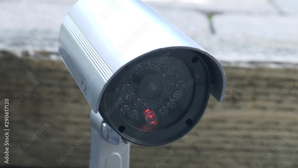 Security video camera moving to scan the area for surveillance purposes ...