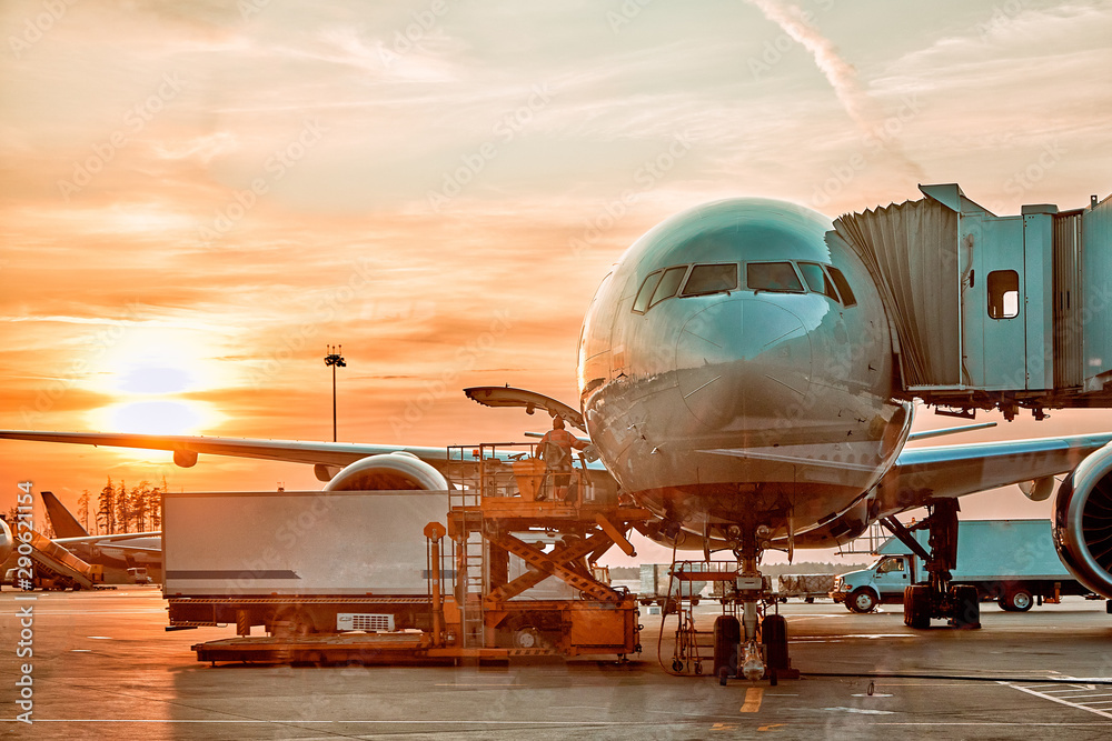 Modern passenger airplane parked to terminal building gate at airside ...