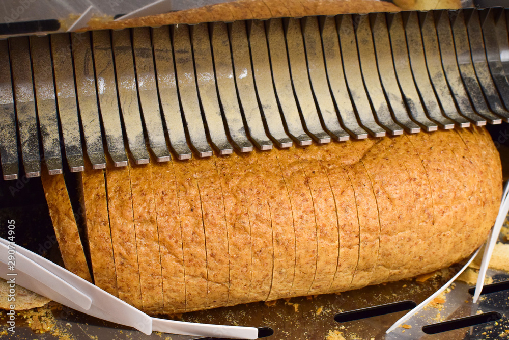 Bread slicer in a supermarket. Industrial bread slicer. Stock Photo ...