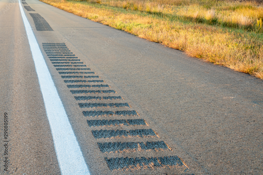 safety rumble strips on a highway shoulder Stock Photo | Adobe Stock
