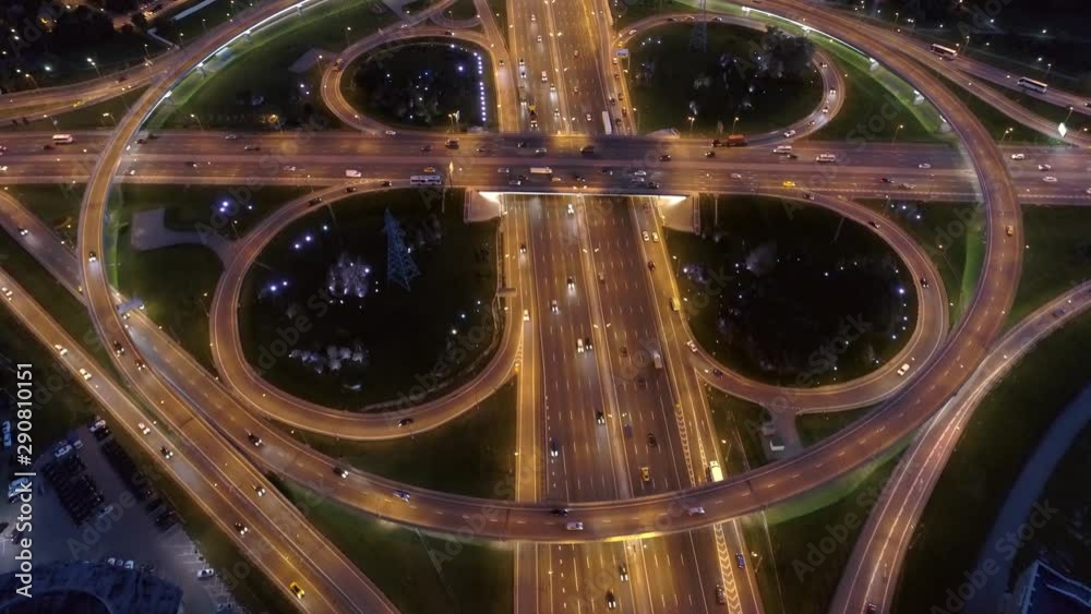 Cinematic flight over clover leaf road night complex intersection in ...