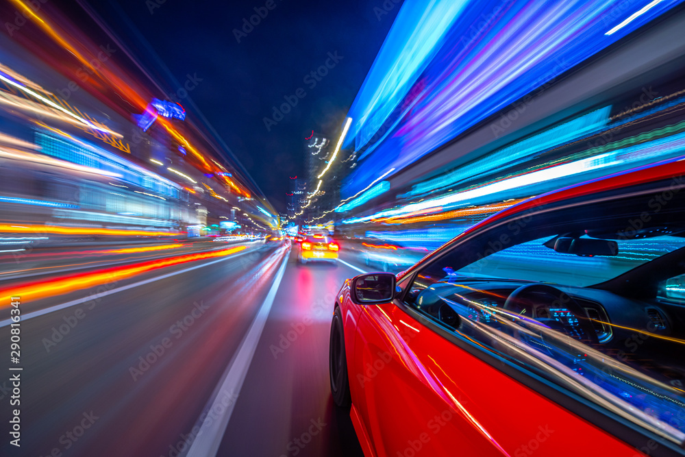 View from Side of a Red Muscle Car moving in a night city, Blured road ...