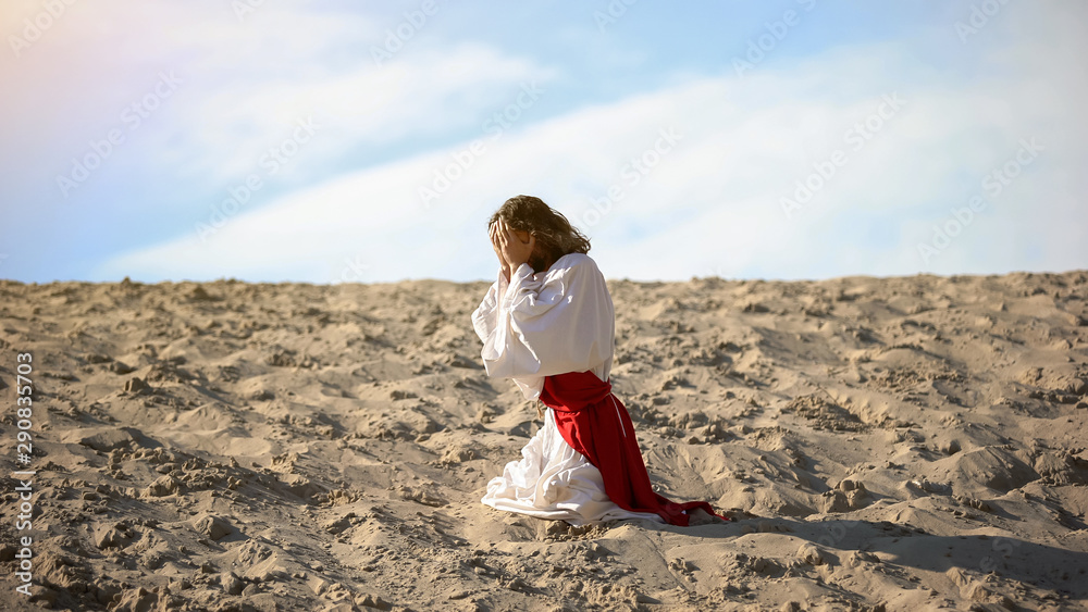 Man in robe repenting for sins, praying to God in desert, pangs of ...