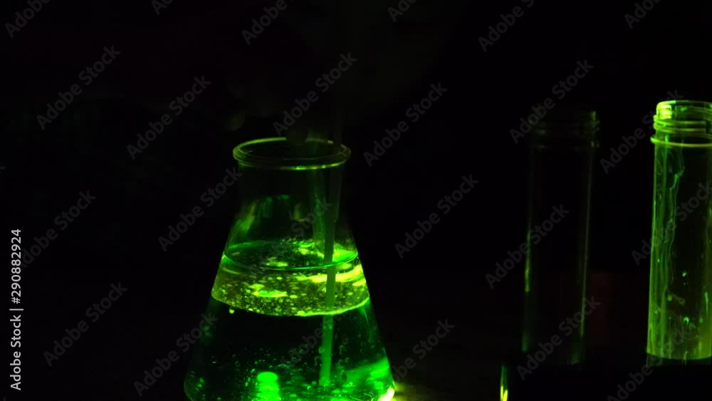 A glowing Science lab for kids with fluorescent green liquid inside of ...