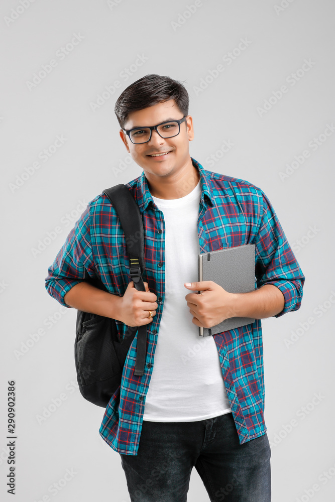 Indian college boy with Holding bag and books 素材庫相片 | Adobe Stock