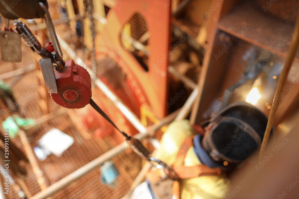 Top view welder wearing safety helmet fall arrest harness using fall ...