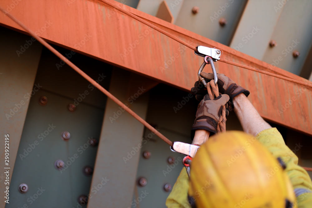 Closeup picture of male rope access worker hand wearing safety glove ...