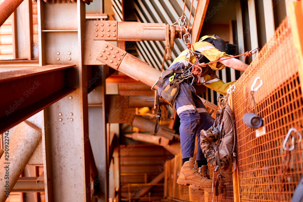 Wide angle view picture of male rope access welder worker wearing full ...