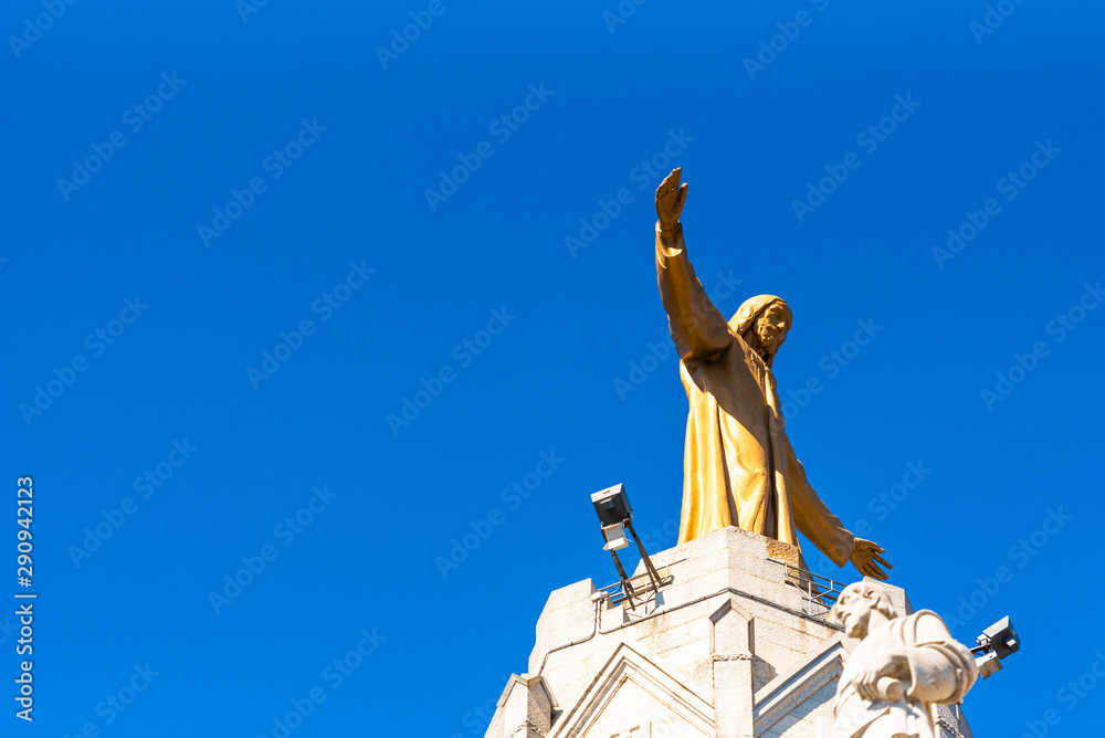 Golden Statue of Jesus Christ on the facade of the Temple of the Sacred ...