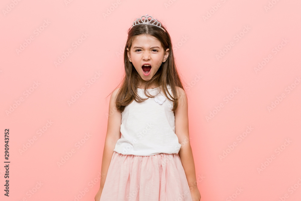 Little girl wearing a princess look screaming very angry and aggressive ...