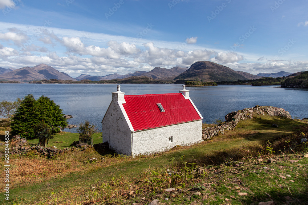 Cottage house with a red roof on the shores of Loch Shieldaig in ...