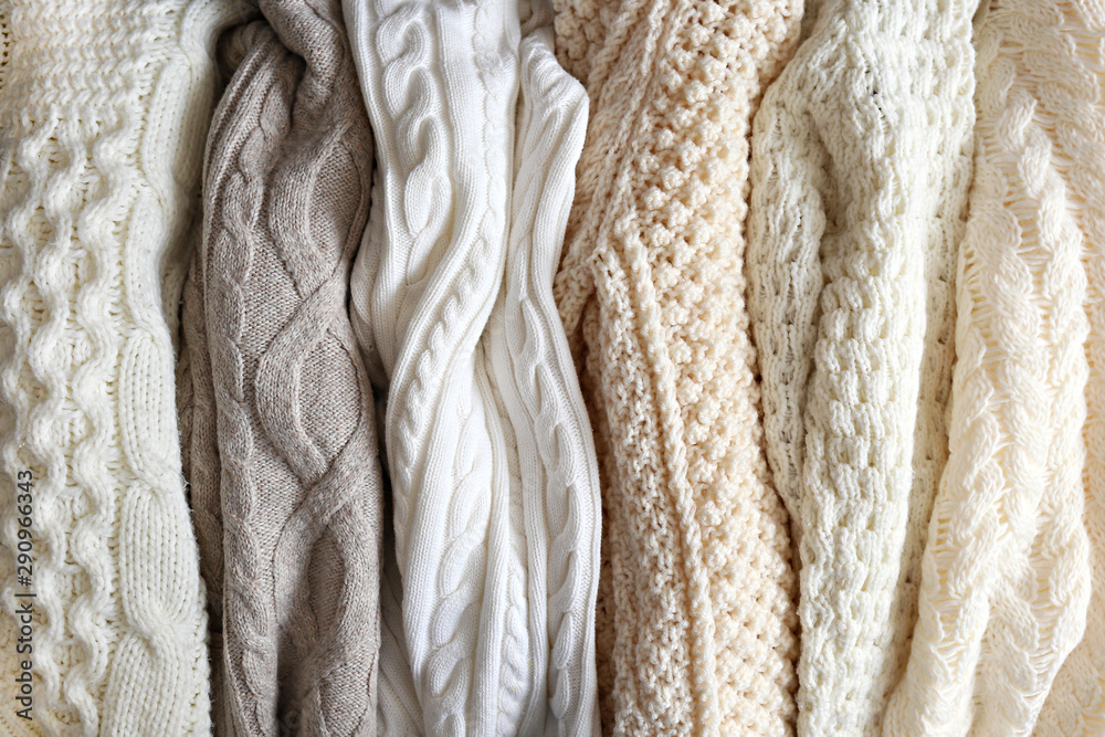 Bunch of knitted warm pastel color sweaters with different vertical ...