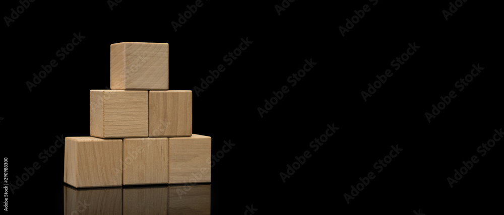 Wood cube arrange in pyramid shape on black background, business ...