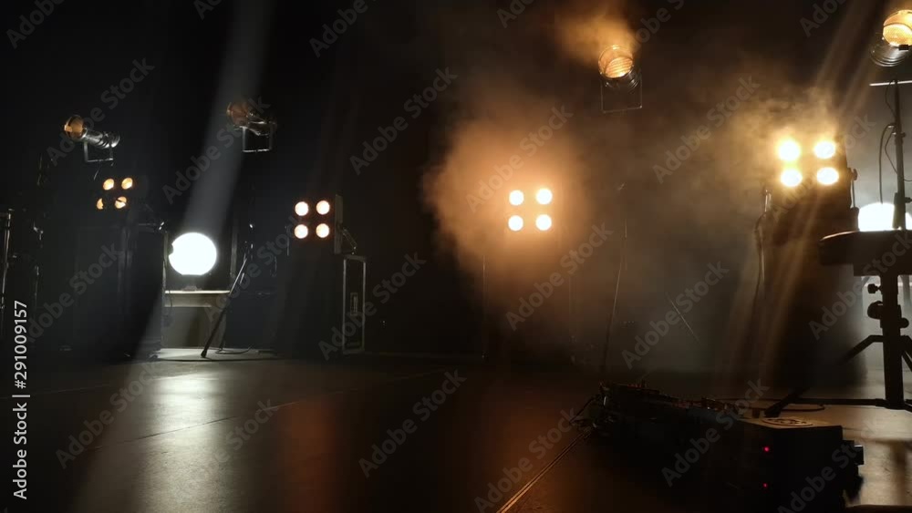 Close-up video of a concert stage and lighting fixtures on it. Smoke ...