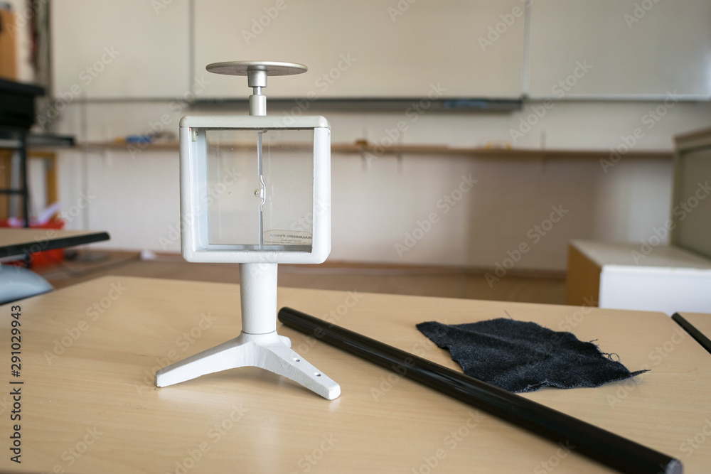 Traditional electroscope with rod and cloth. Physics experiment. Stock ...