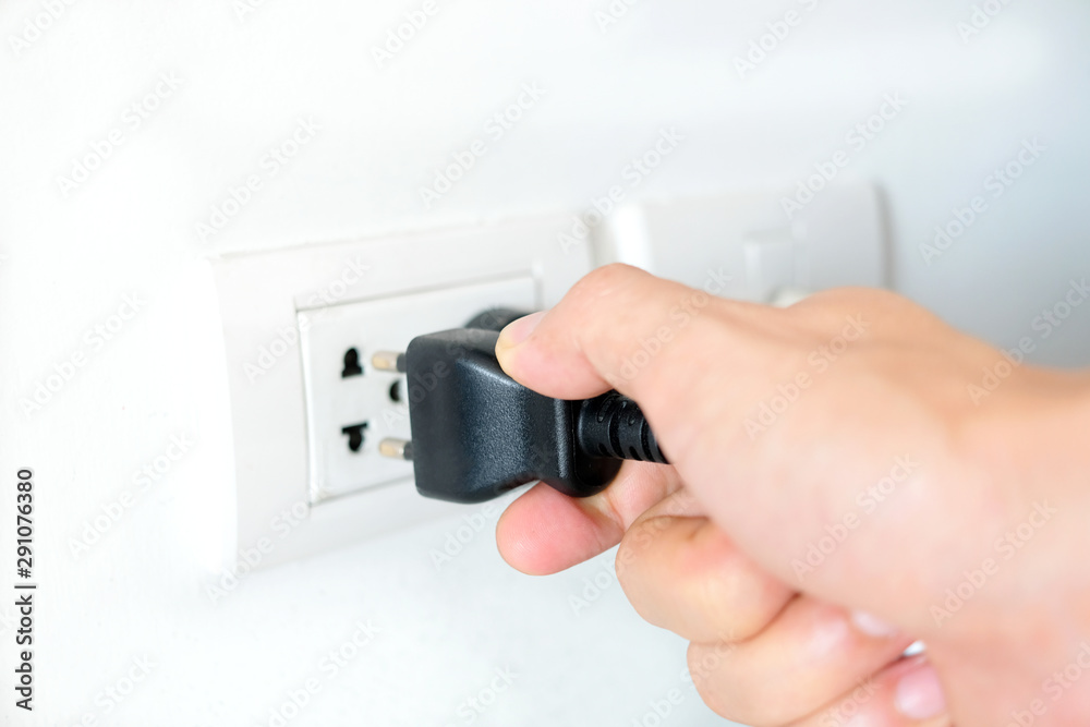 Hand of Electrical Appliances He was pulling the plug. Out of the plug ...
