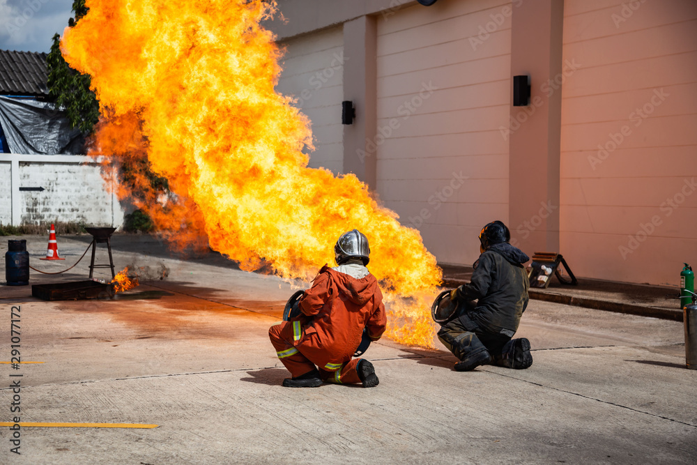 Firemen using extinguisher and water for fight fire during firefight ...
